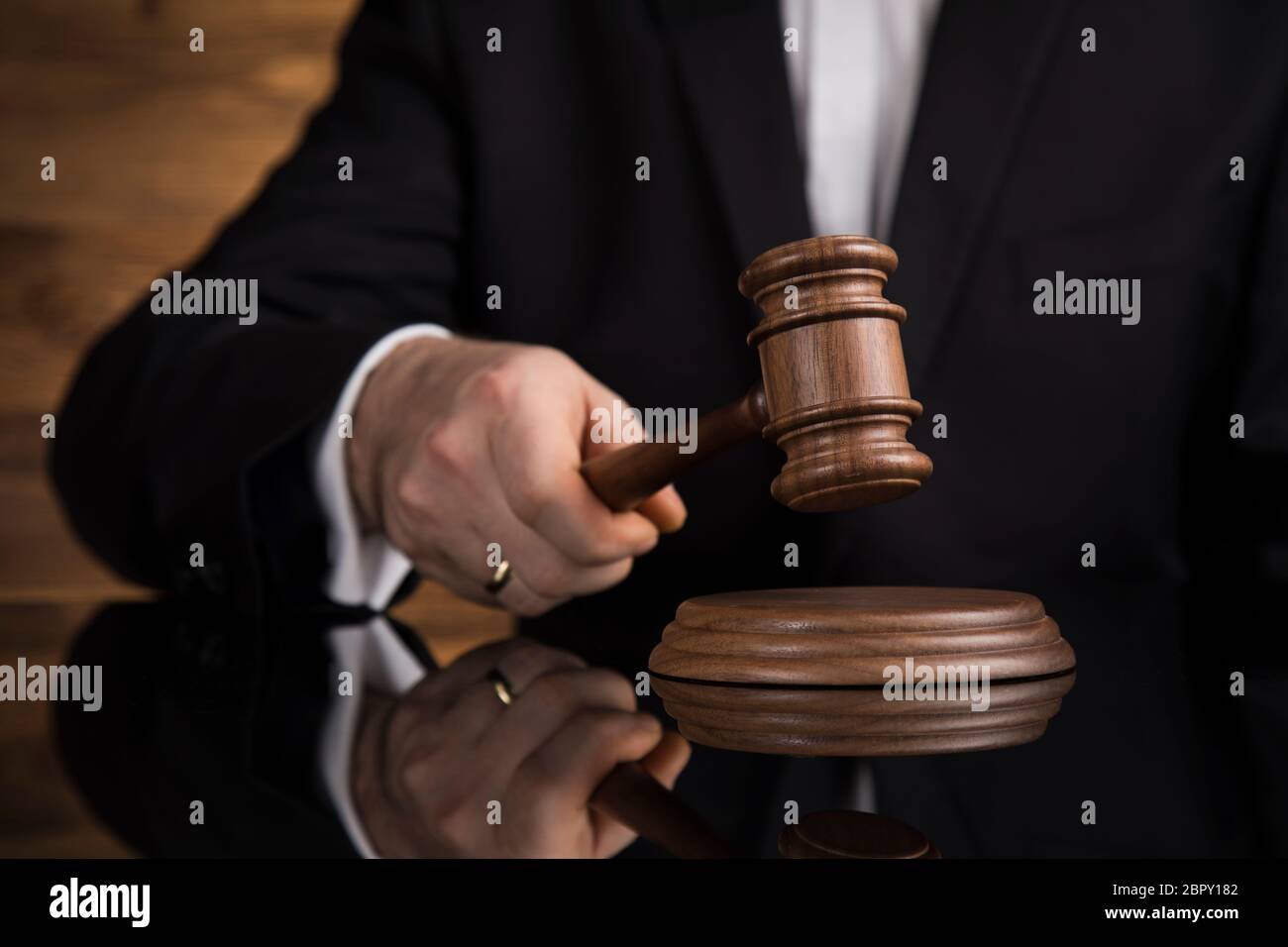 Justice and law concept, Male judge in a courtroom striking the gavel ...