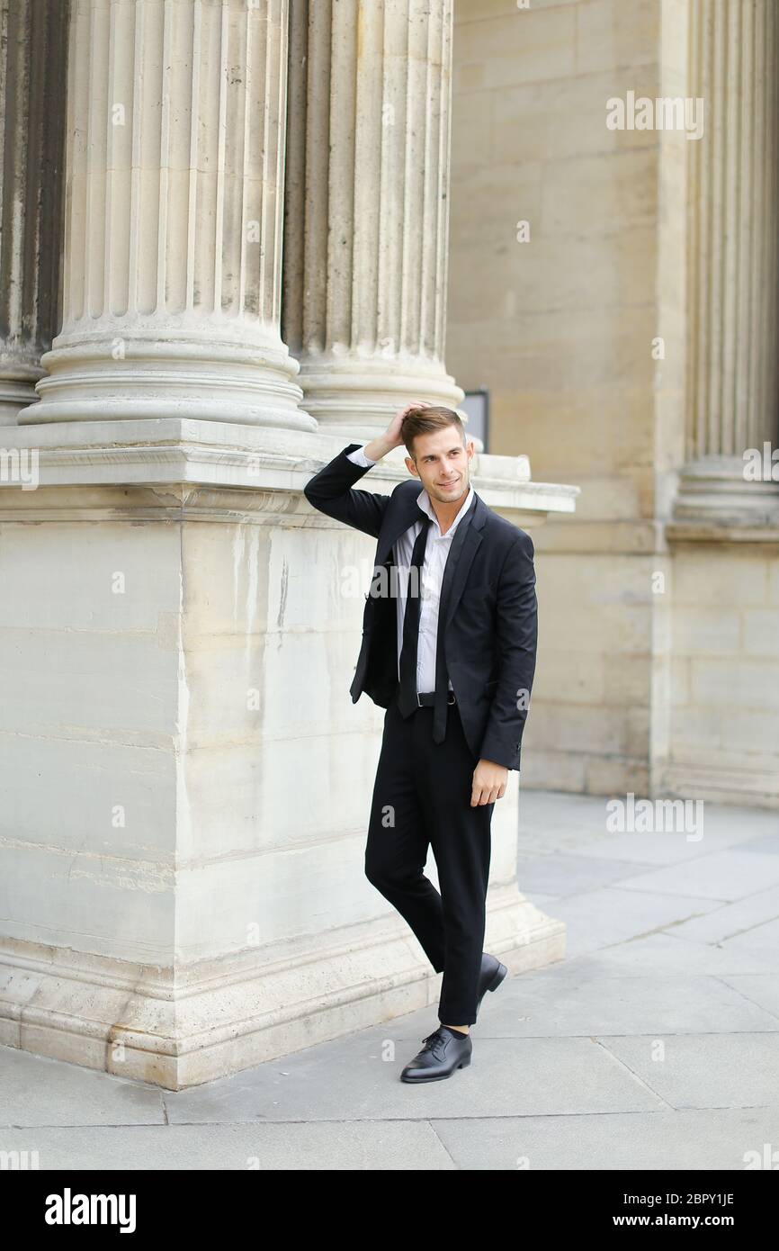 Young man leaning on column hi-res stock photography and images - Alamy