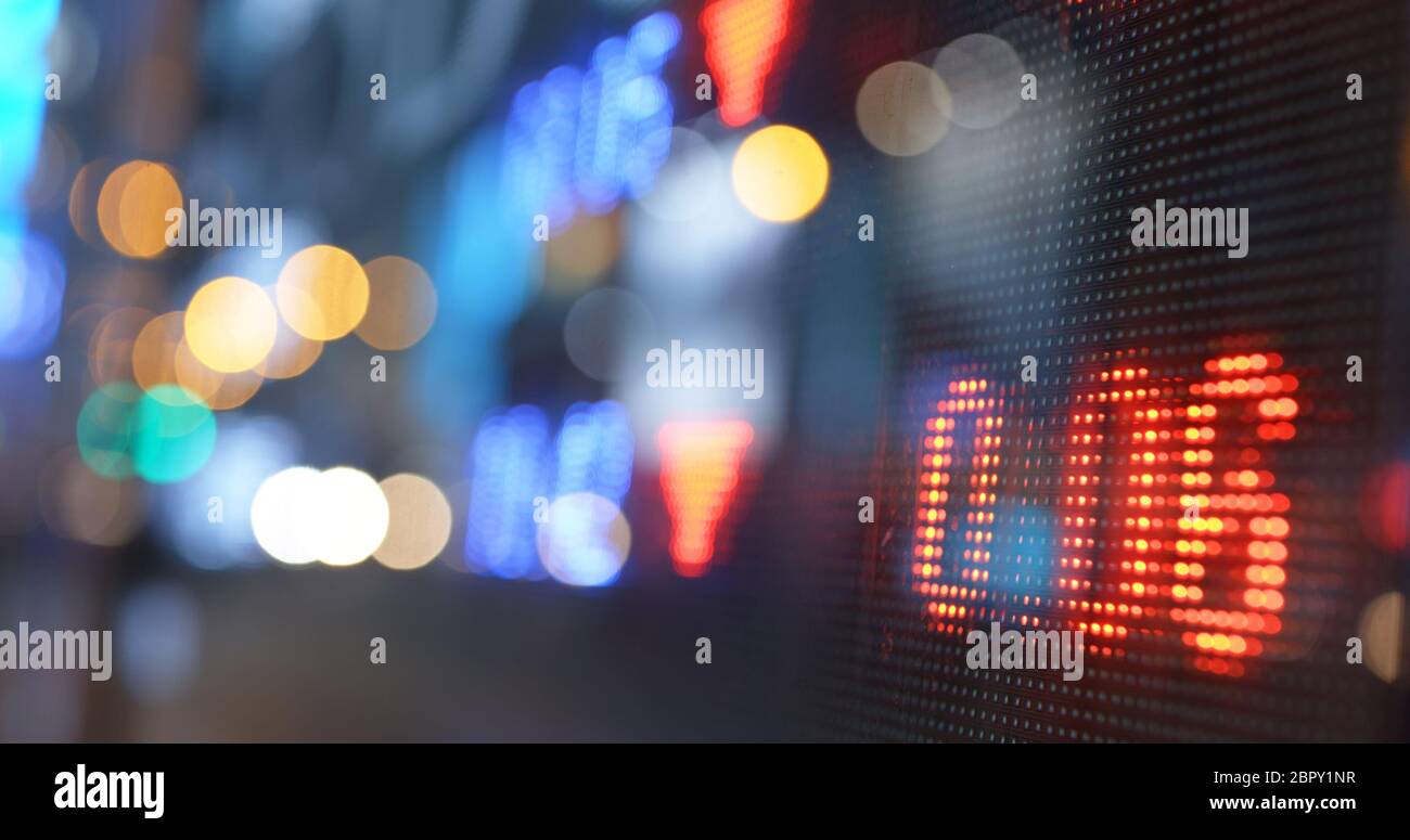 Stock market display screen in city at night Stock Photo - Alamy
