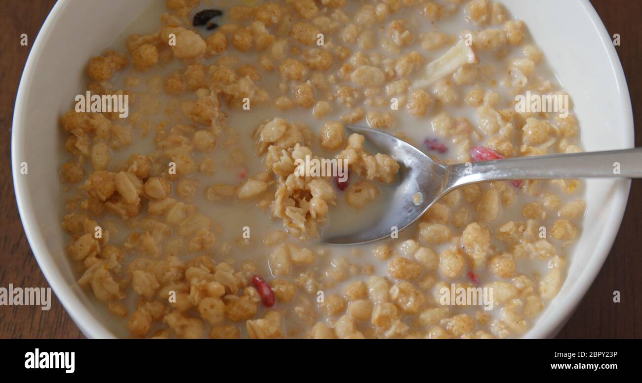 Adding milk into cereal Stock Photo - Alamy
