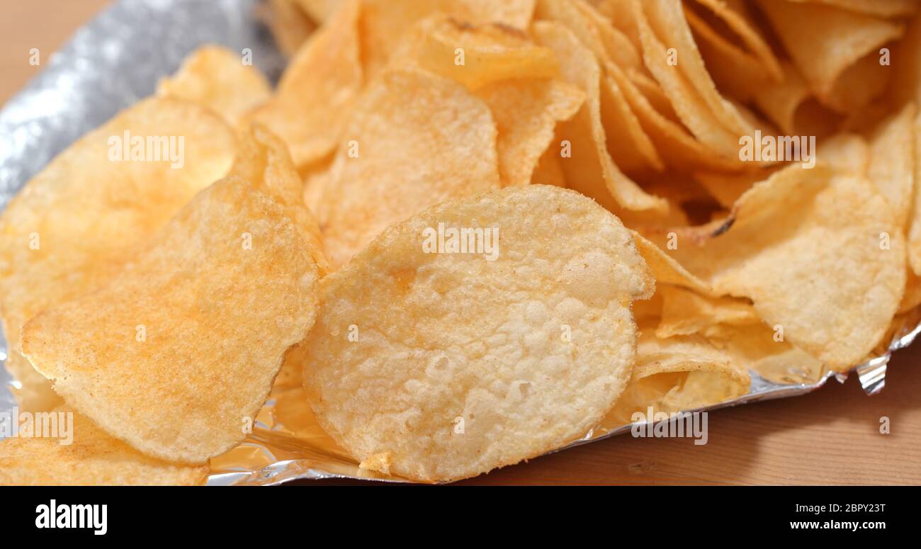 Eating potato chip Stock Photo - Alamy