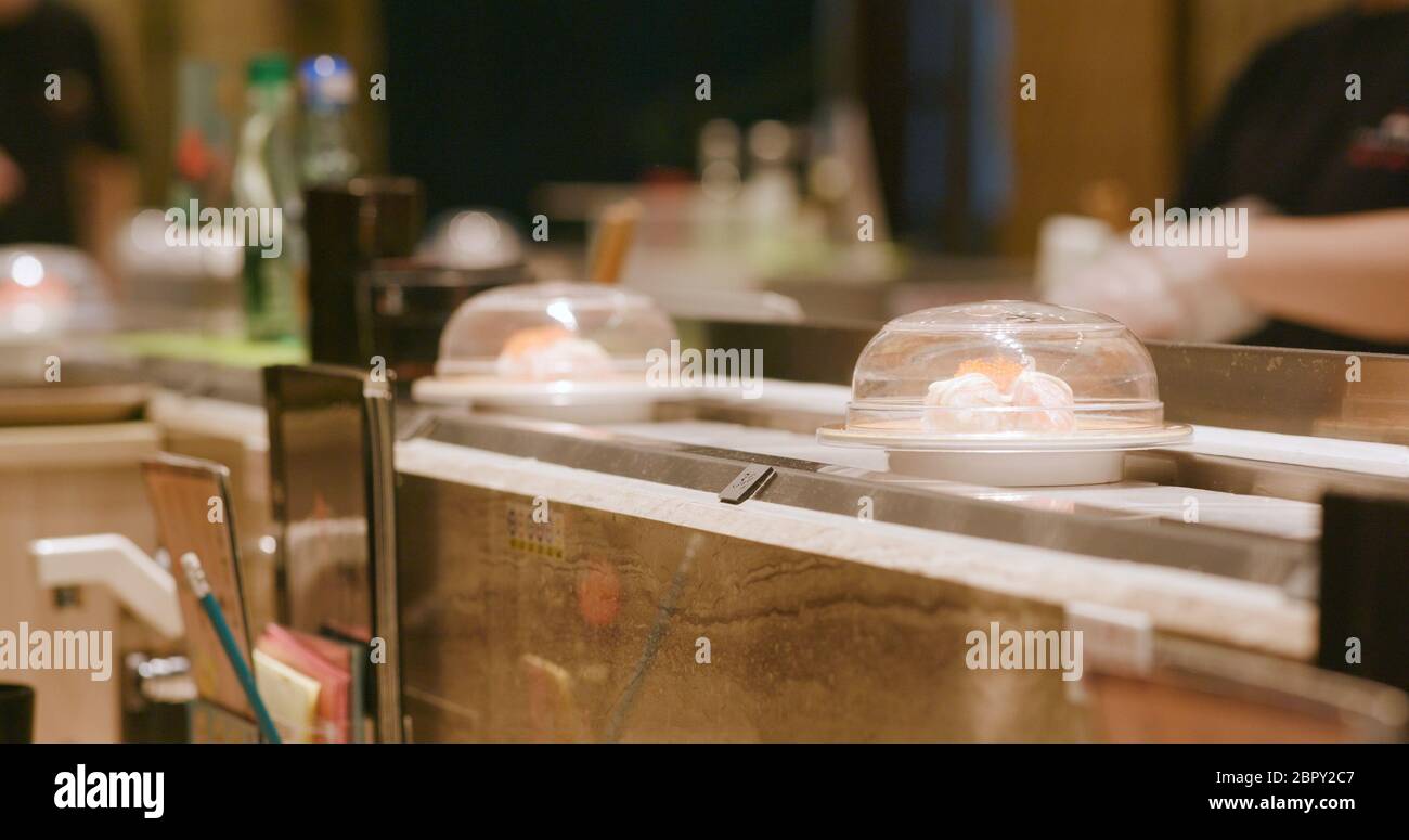 Sushi conveyor belt in Japanese sushi restaurant Stock Photo - Alamy