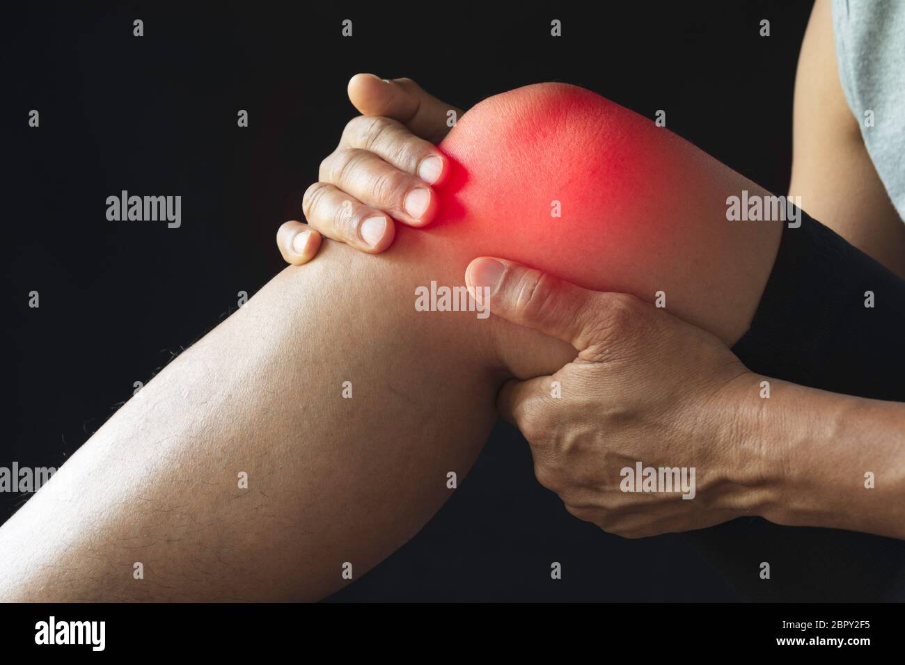 The male clings to a bad knee. The pain in his knee. Health and painful ...