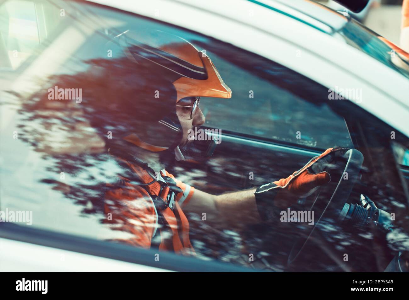 Rally driver, the man in the helmet tensely and seriously looking ...