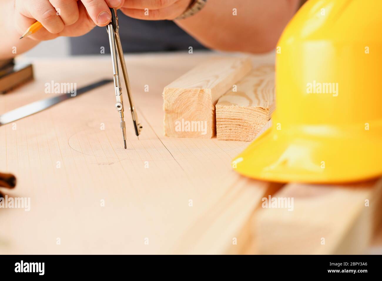 Arms of worker making structure plan on scaled paper Stock Photo - Alamy