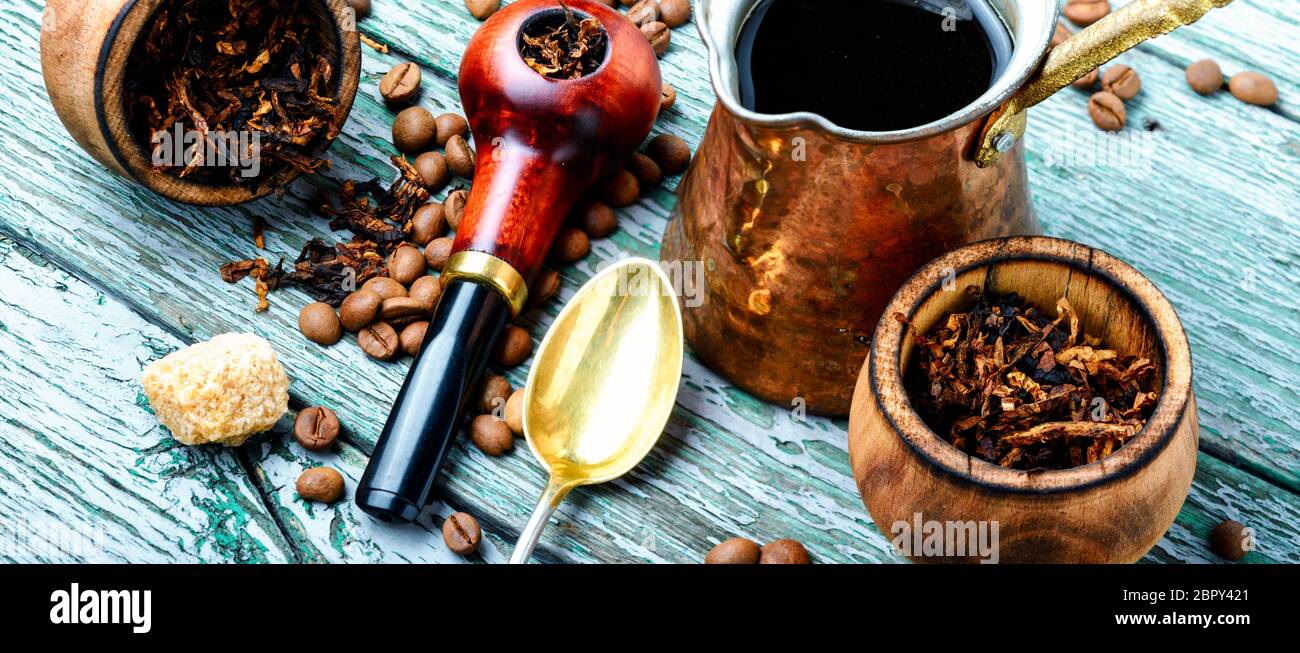 Stylish tobacco pipe with tobacco and brewed coffee Stock Photo - Alamy