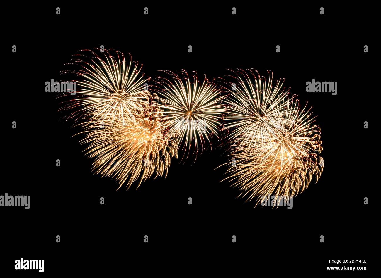 Golden and red exploded fireworks display, isolated on black background ...