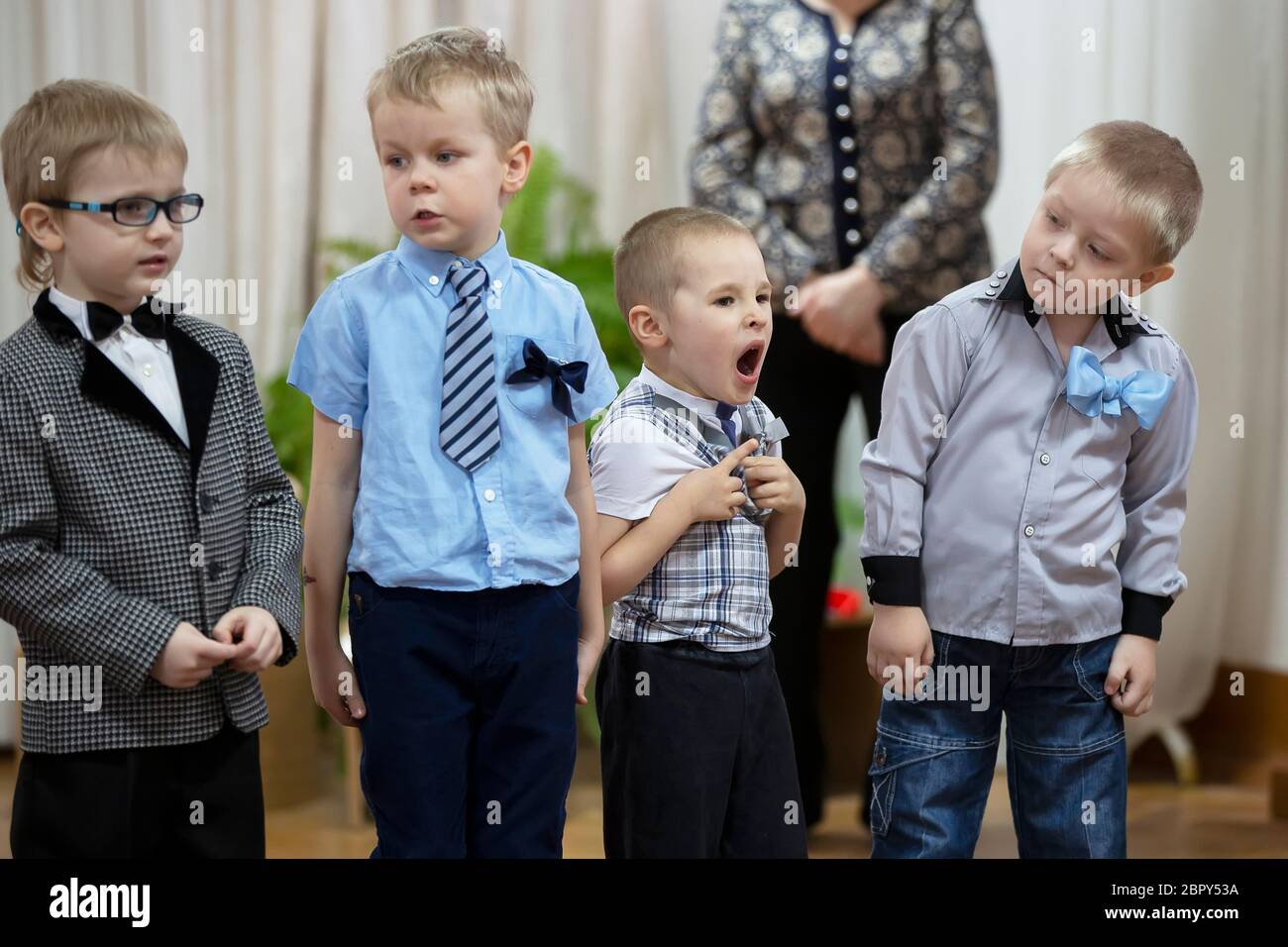 Group of preschoolers at a matinee. Funny children perform at a holiday ...