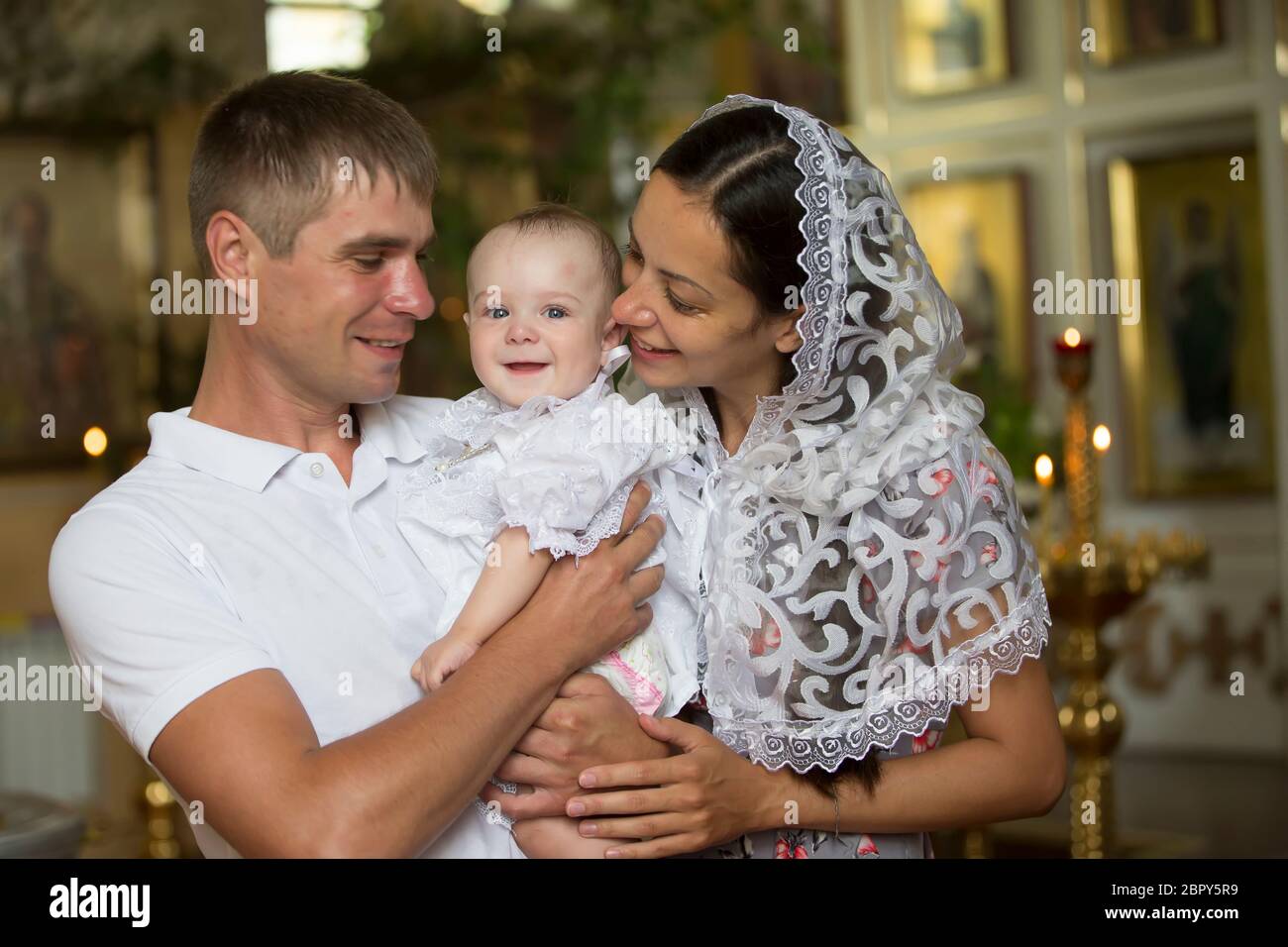 Parents with a child in an Orthodox church Stock Photo - Alamy