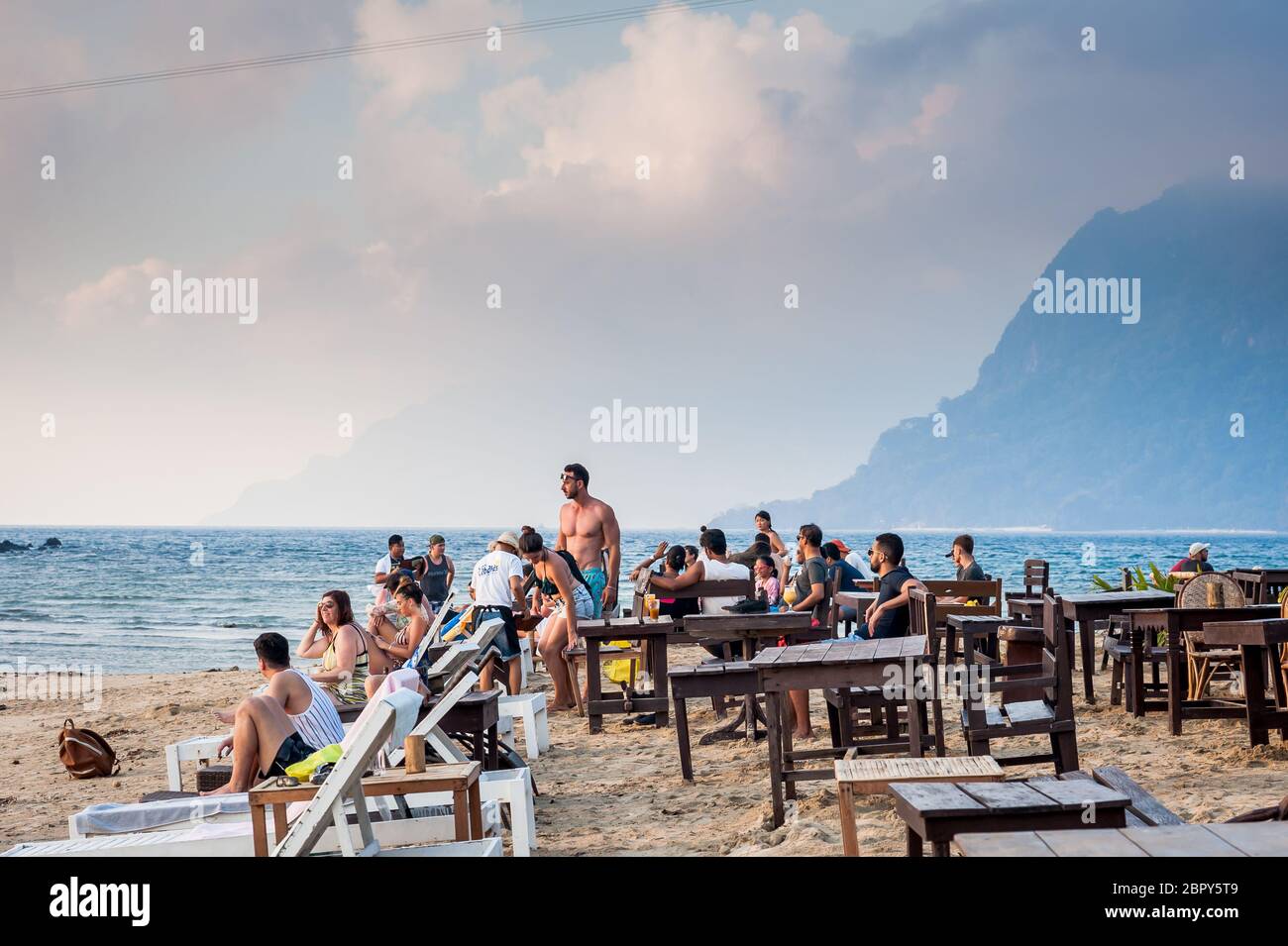 Tourists gather to enjoy and photograph the sunset at Las Cabanas Beach ...