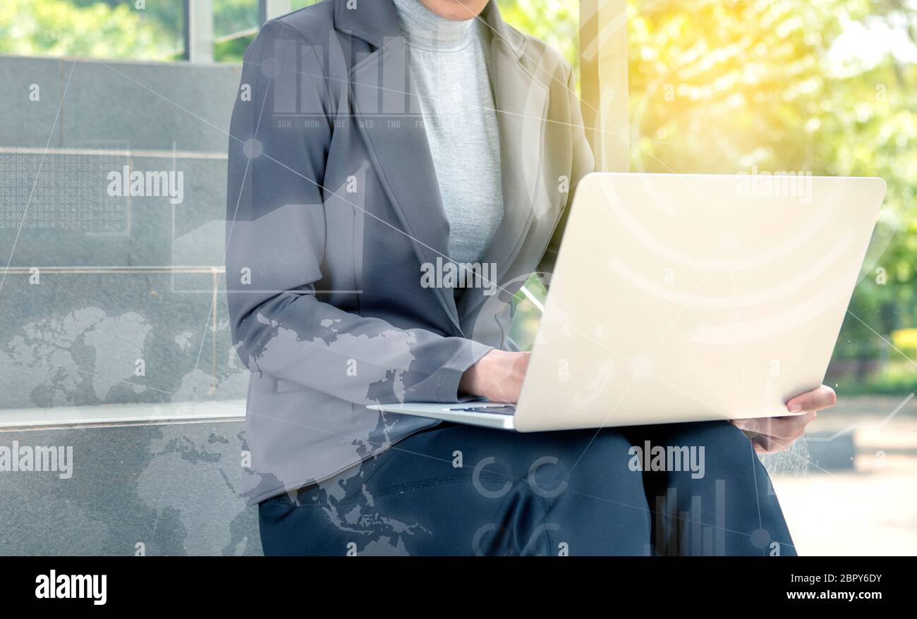 Business woman working using laptop with virtual screen which display ...