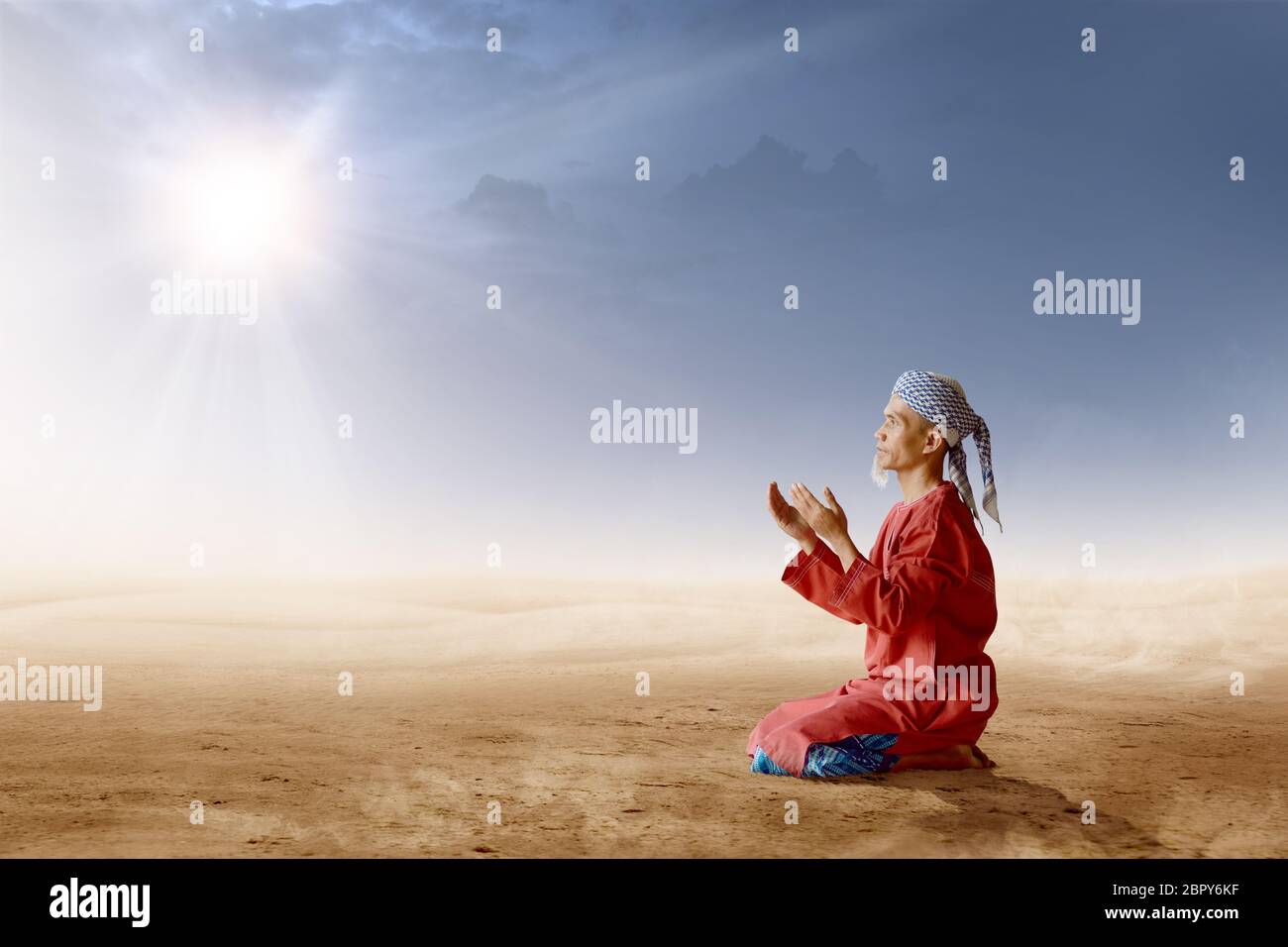 Asian muslim man with turban in his head kneeling and praying with ...