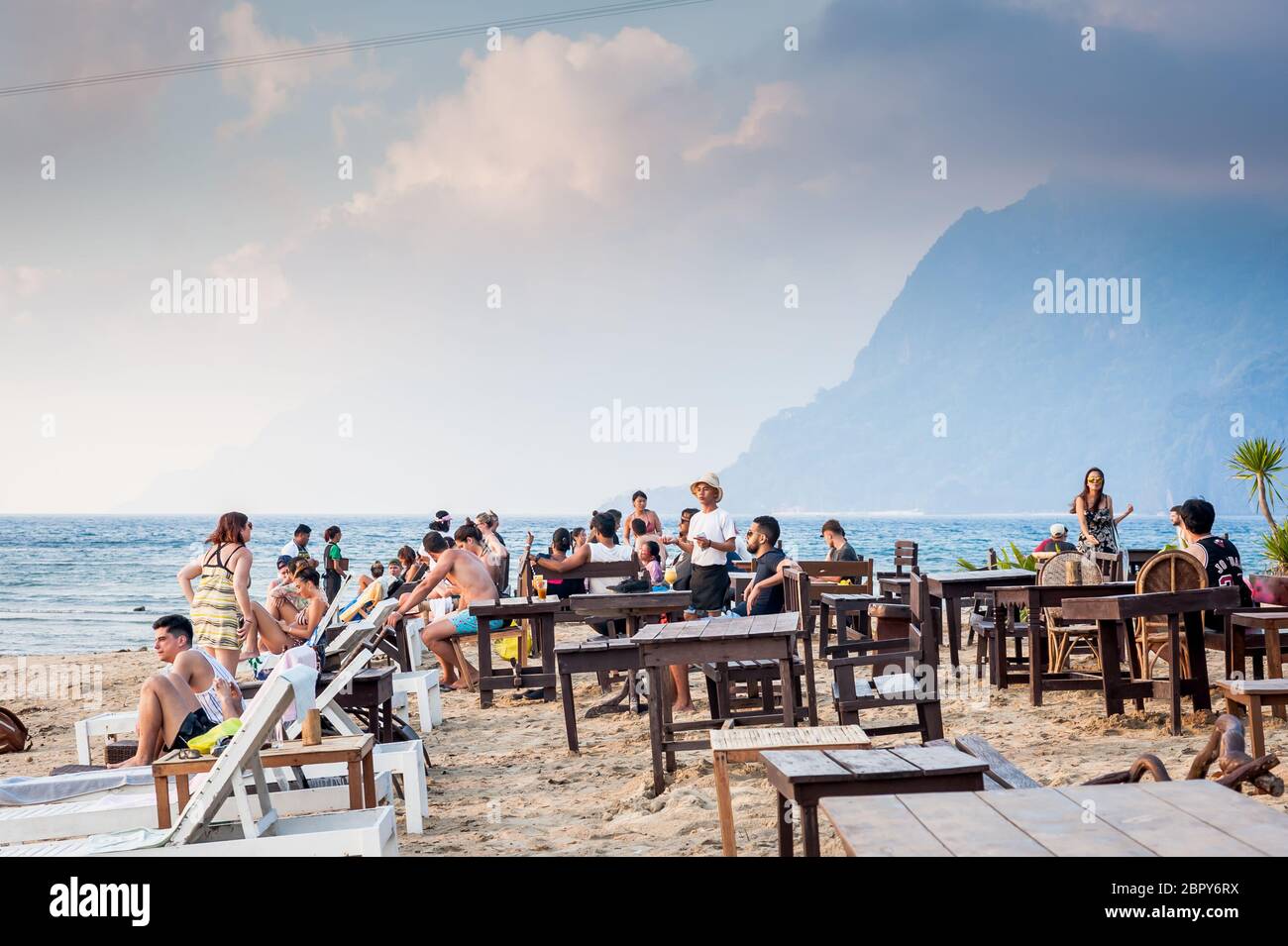 Tourists gather to enjoy and photograph the sunset at Las Cabanas Beach ...