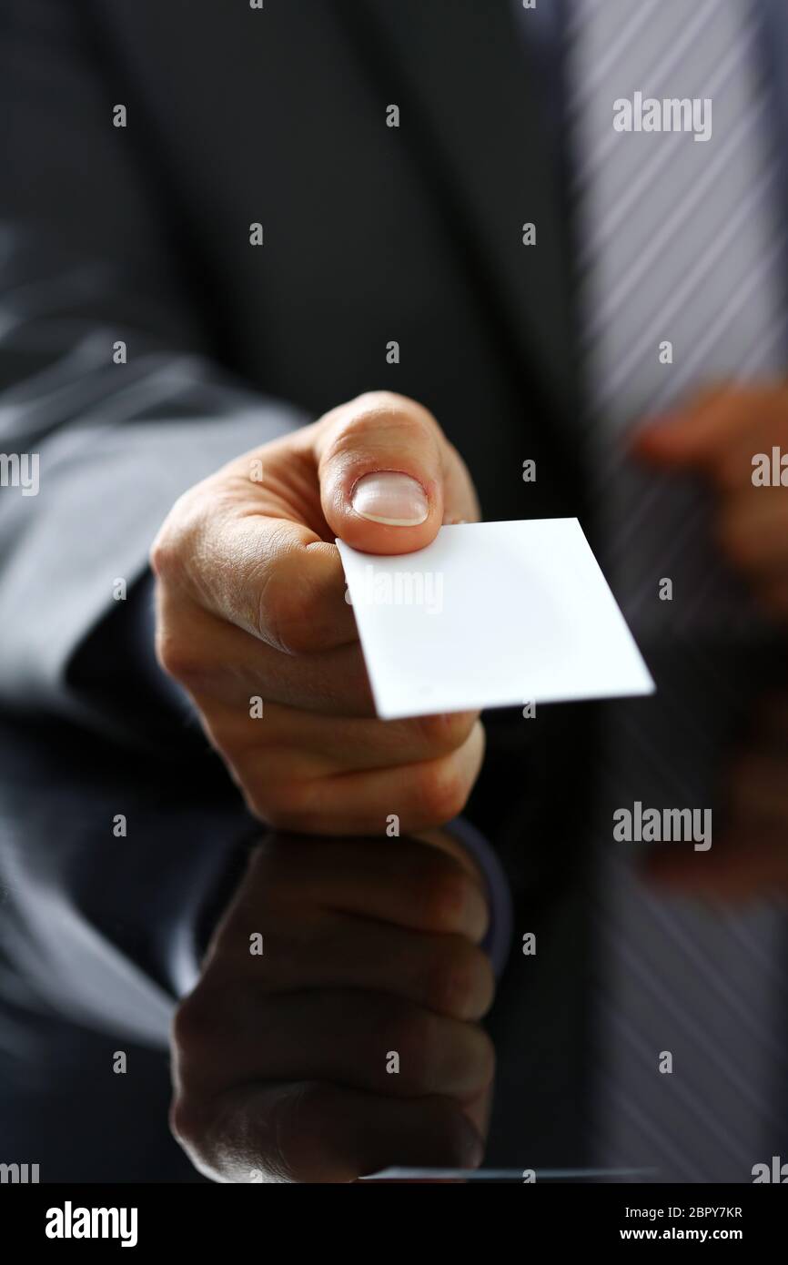 Male arm in suit give blank calling card to visitor Stock Photo - Alamy