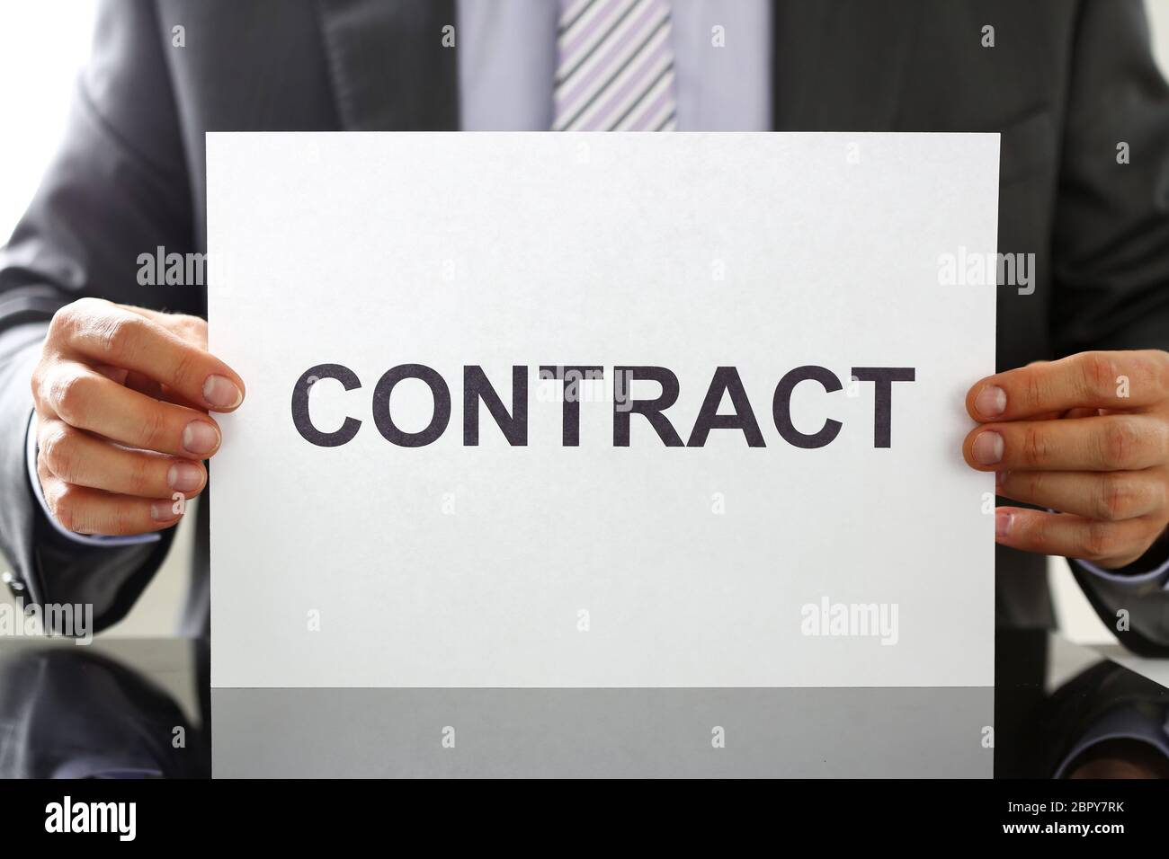 Man in suit and tie hold in arms contract Stock Photo - Alamy