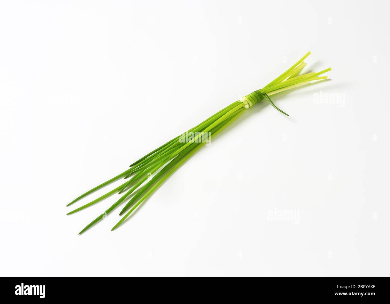 Fresh chives leaves on white background Stock Photo - Alamy