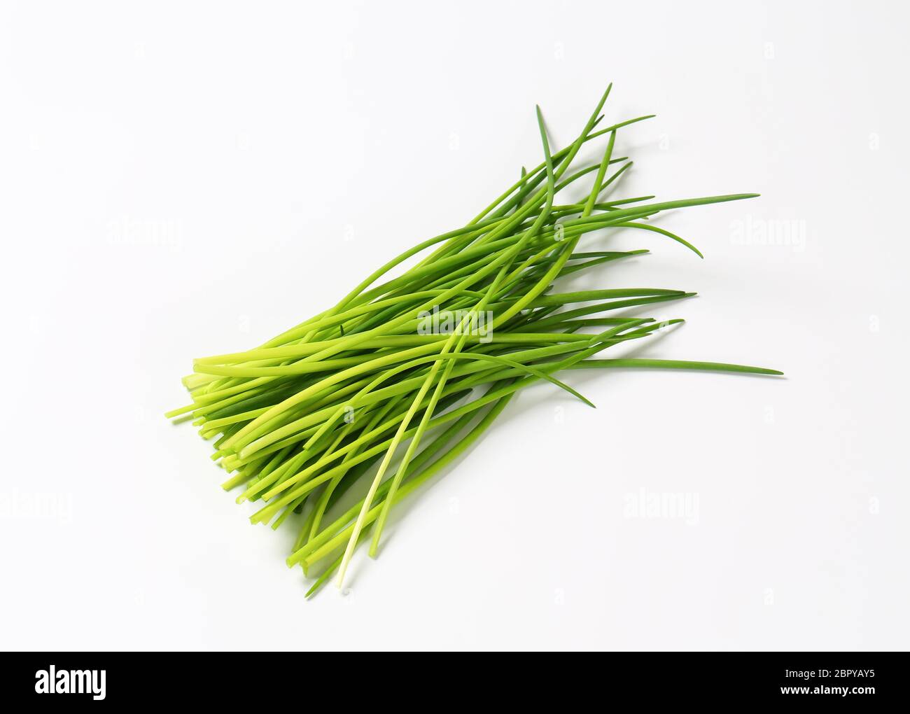 Fresh chives leaves on white background Stock Photo - Alamy