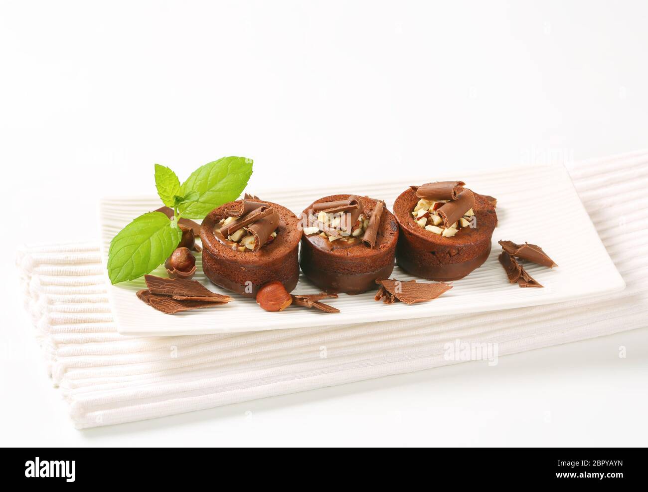Mini chocolate cakes with hazelnut filling Stock Photo - Alamy