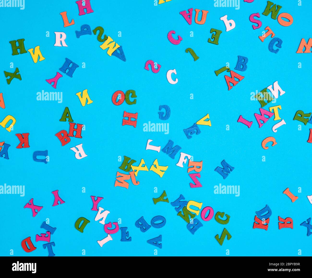 multicolored English alphabet letters on a blue background, full frame ...