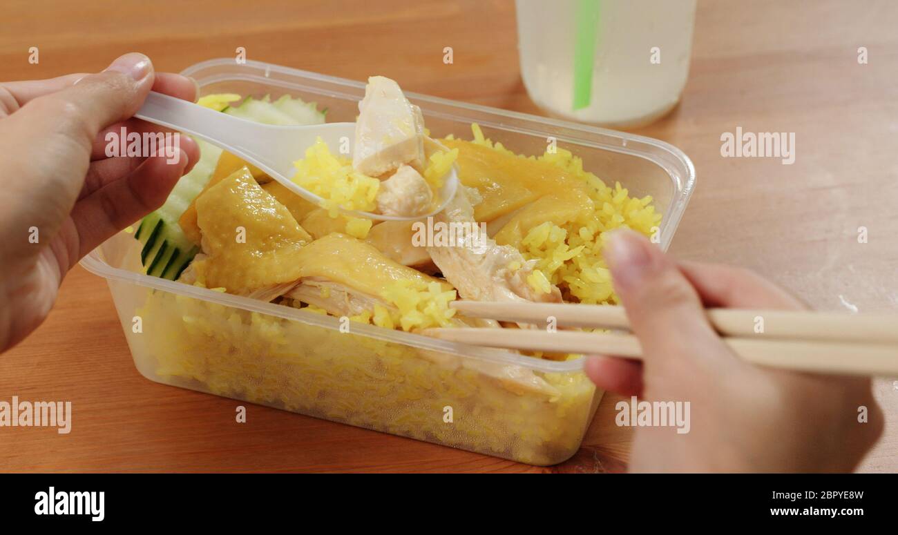 Eating Chicken rice in take away box Stock Photo - Alamy