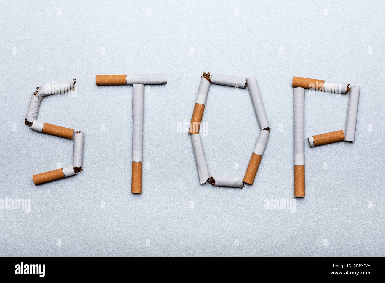 The Word Stop Spelled Using Cigarettes On White Background Stock Photo ...
