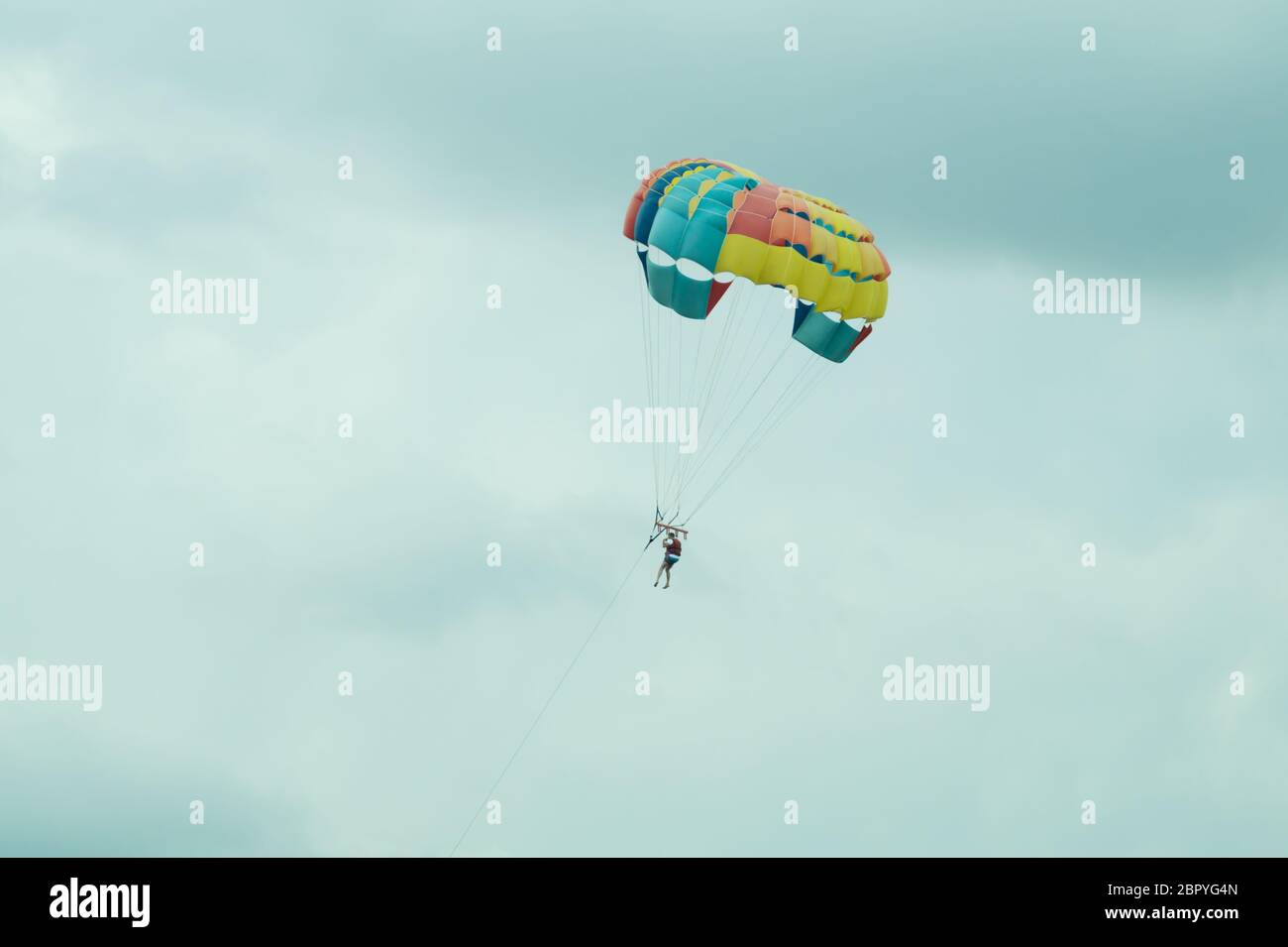 Skydiver flying with a colorful parachute Stock Photo - Alamy