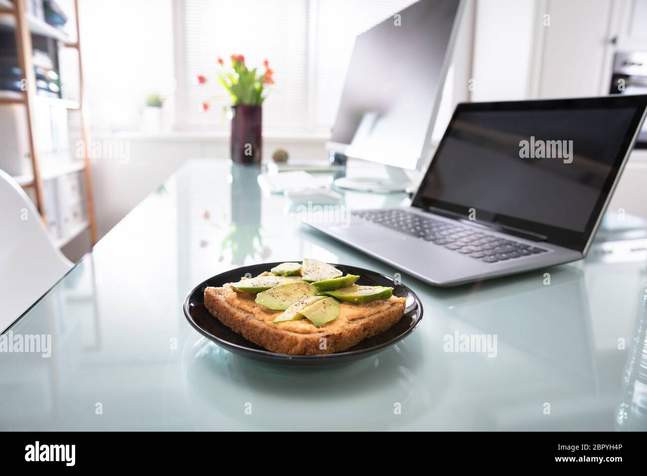 Healthy Sandwich In Plate Near Laptop Over Reflective Desk Stock Photo ...