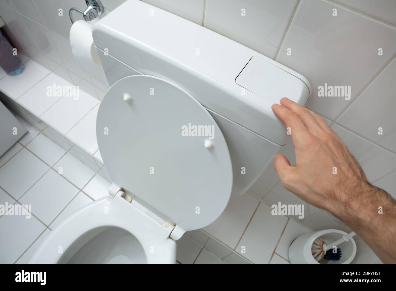 Hand flushing the toilet hi-res stock photography and images - Alamy
