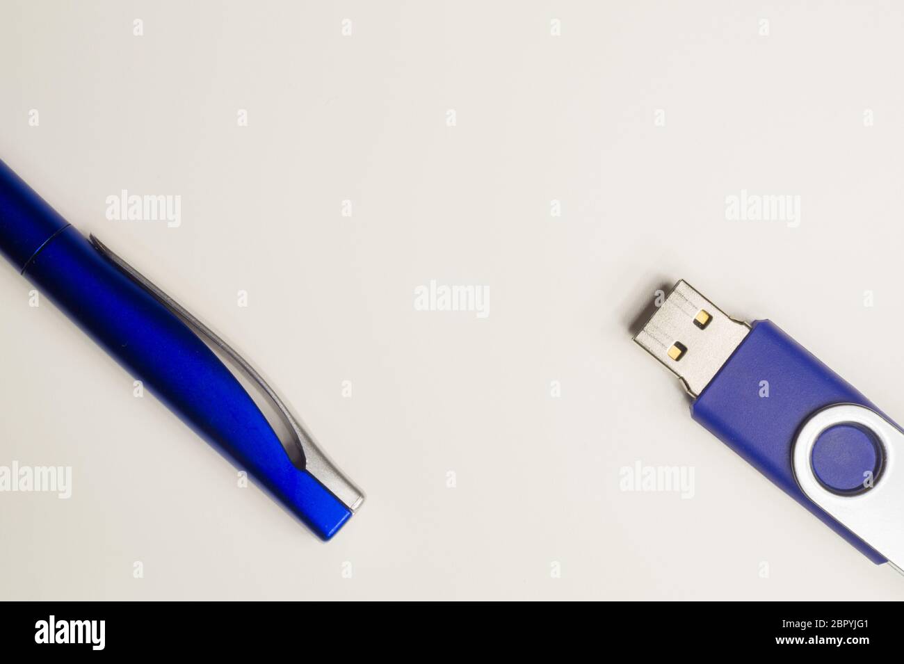 Usb flash drive and blue pen isolated on white background. copy space ...
