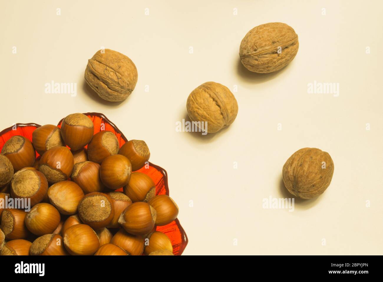 Hazelnuts and walnuts in a bowl isolated on white background Stock ...