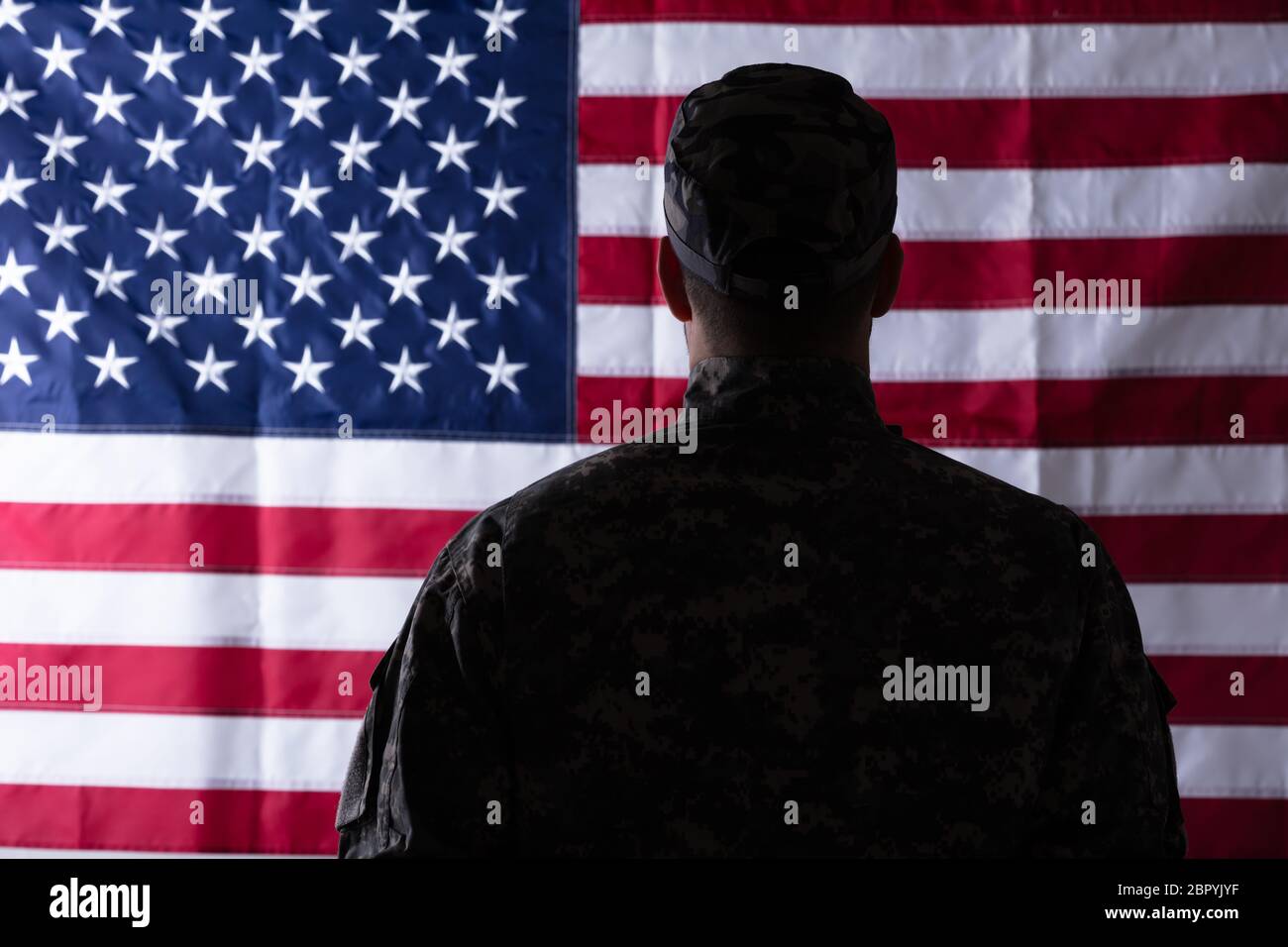 Rear View Of Soldier In Front Of Us Flag Stock Photo - Alamy