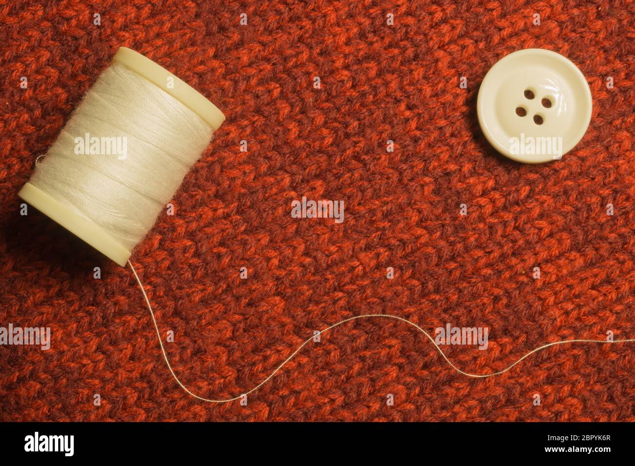 Sewing button with the threads on textile background. copy space Stock ...