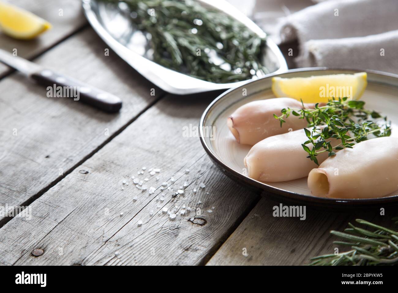 Preparation of raw squid and ingredients on the table Stock Photo - Alamy