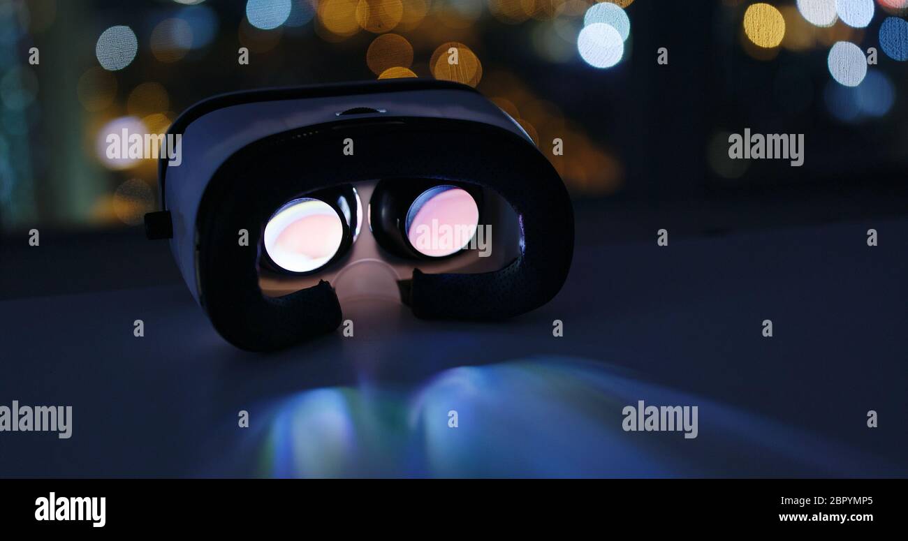 Virtual reality device play video inside at night Stock Photo - Alamy