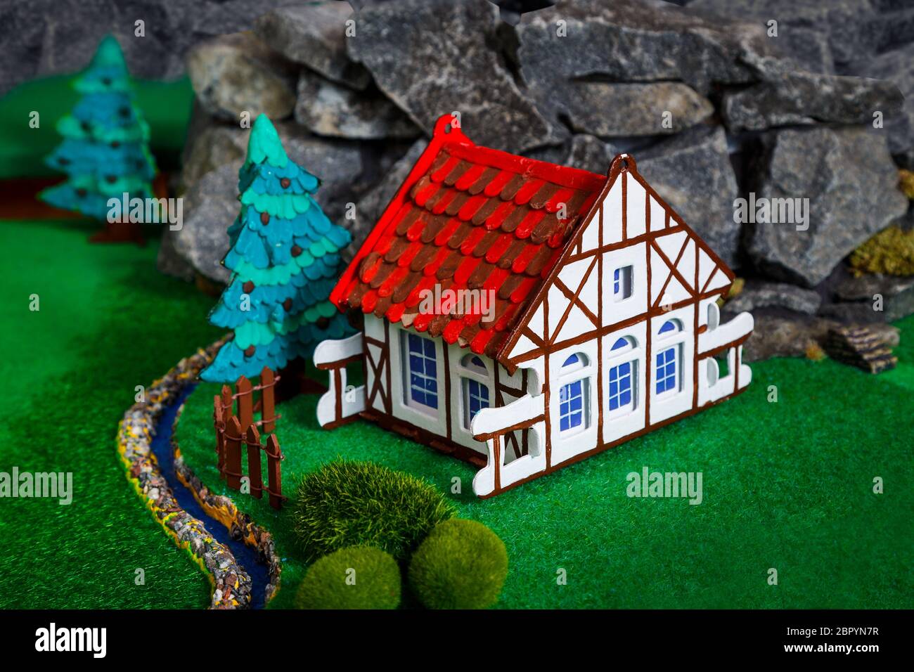Cardboard house on a toy landscape, on artificial green grass Stock ...