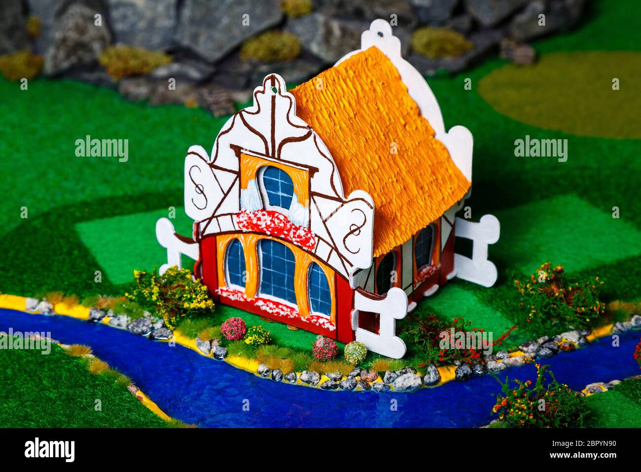 Cardboard house on a toy landscape, on artificial green grass Stock ...