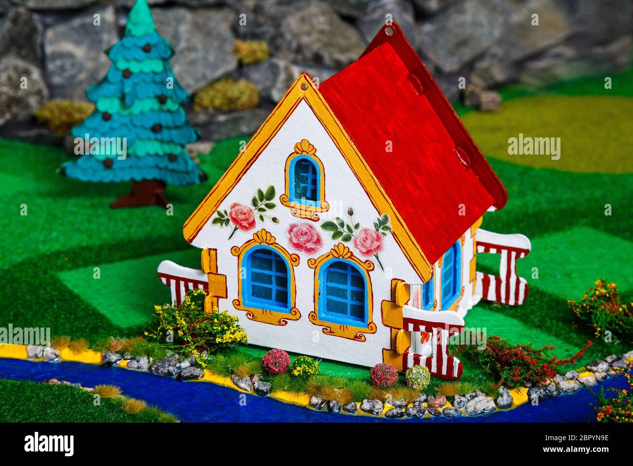 Cardboard house on a toy landscape, on artificial green grass Stock ...