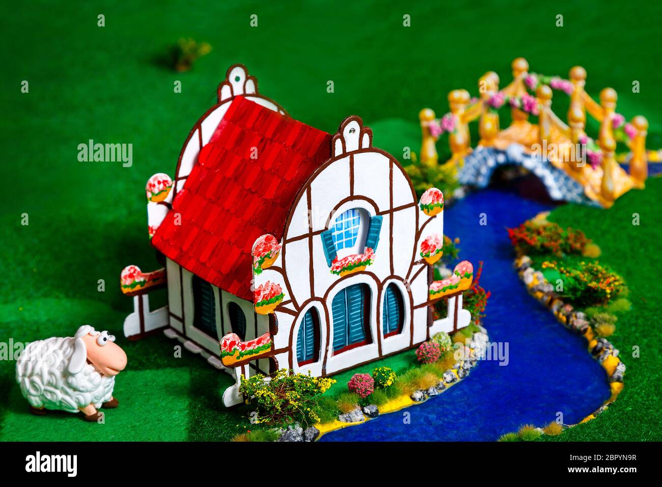 Cardboard house on a toy landscape, on artificial green grass Stock ...