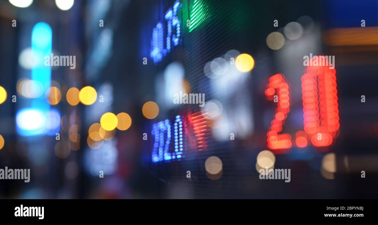 Stock market display screen in city at night Stock Photo - Alamy