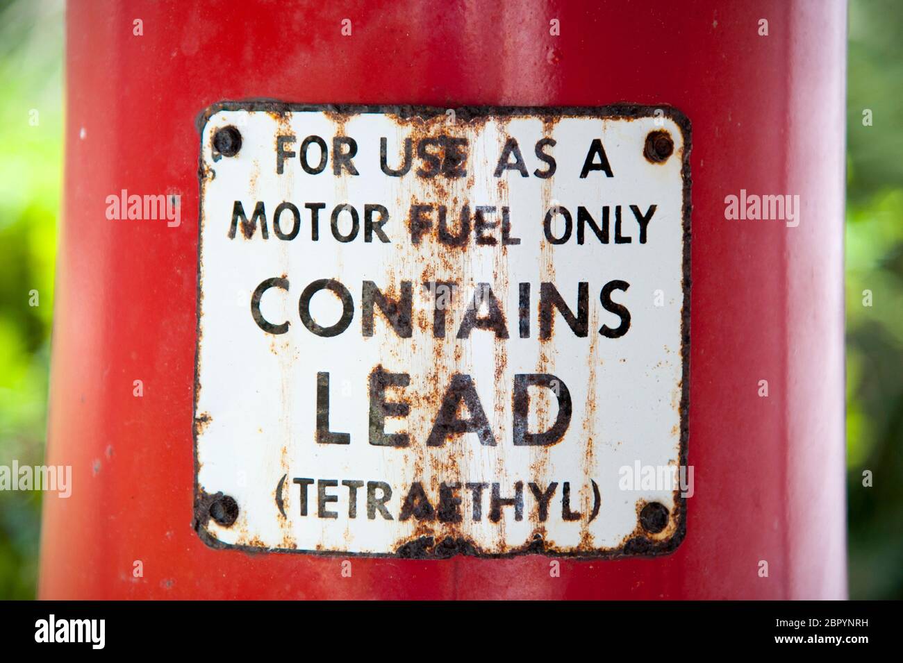 Old vintage rusty fuel pump sign on red pole Stock Photo - Alamy