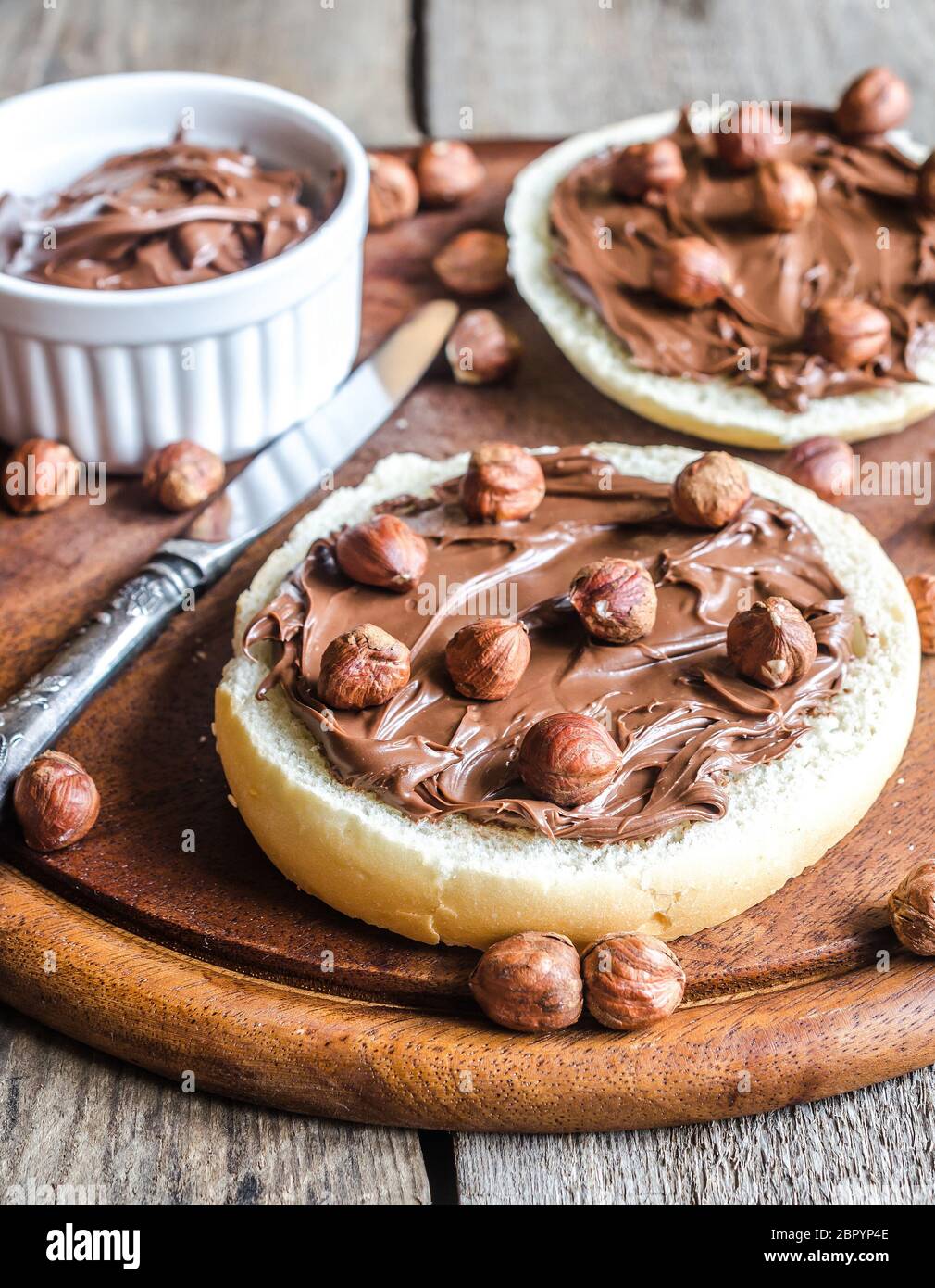 Bun slices with chocolate cream and nuts Stock Photo - Alamy