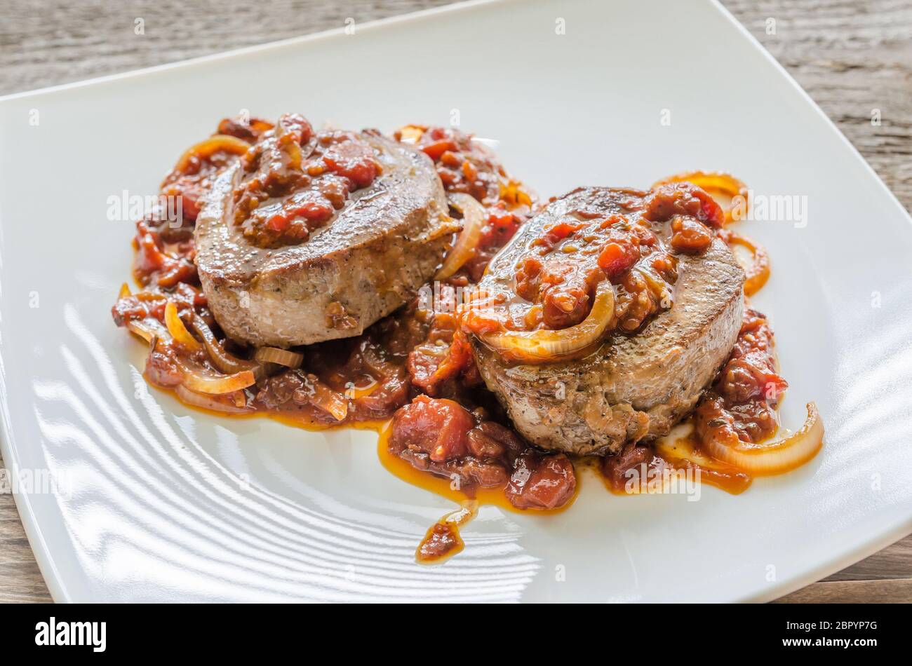 Angus Beef Steaks With Roasted Tomato Sauce Stock Photo - Alamy