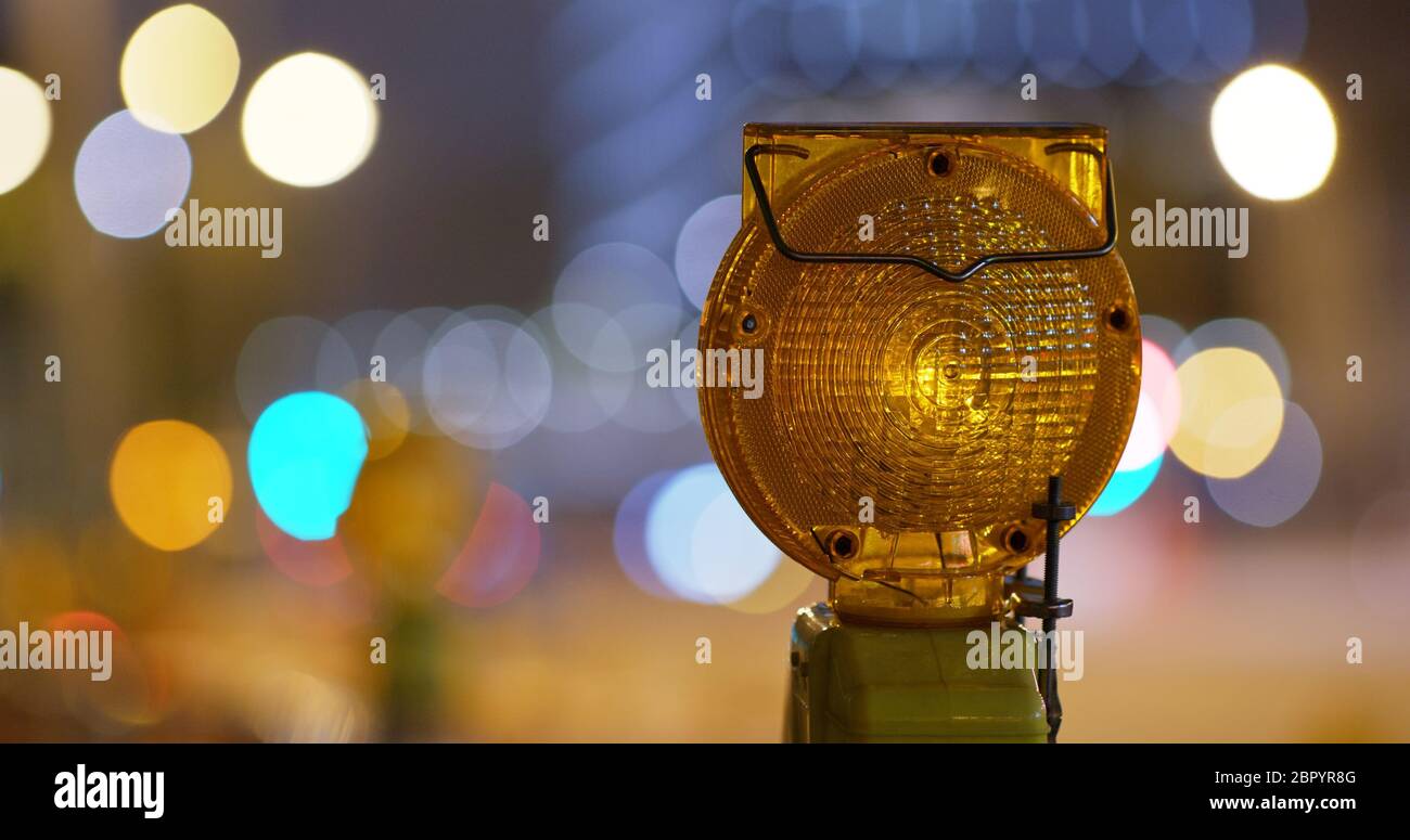 Yellow caution light in the street at night Stock Photo - Alamy