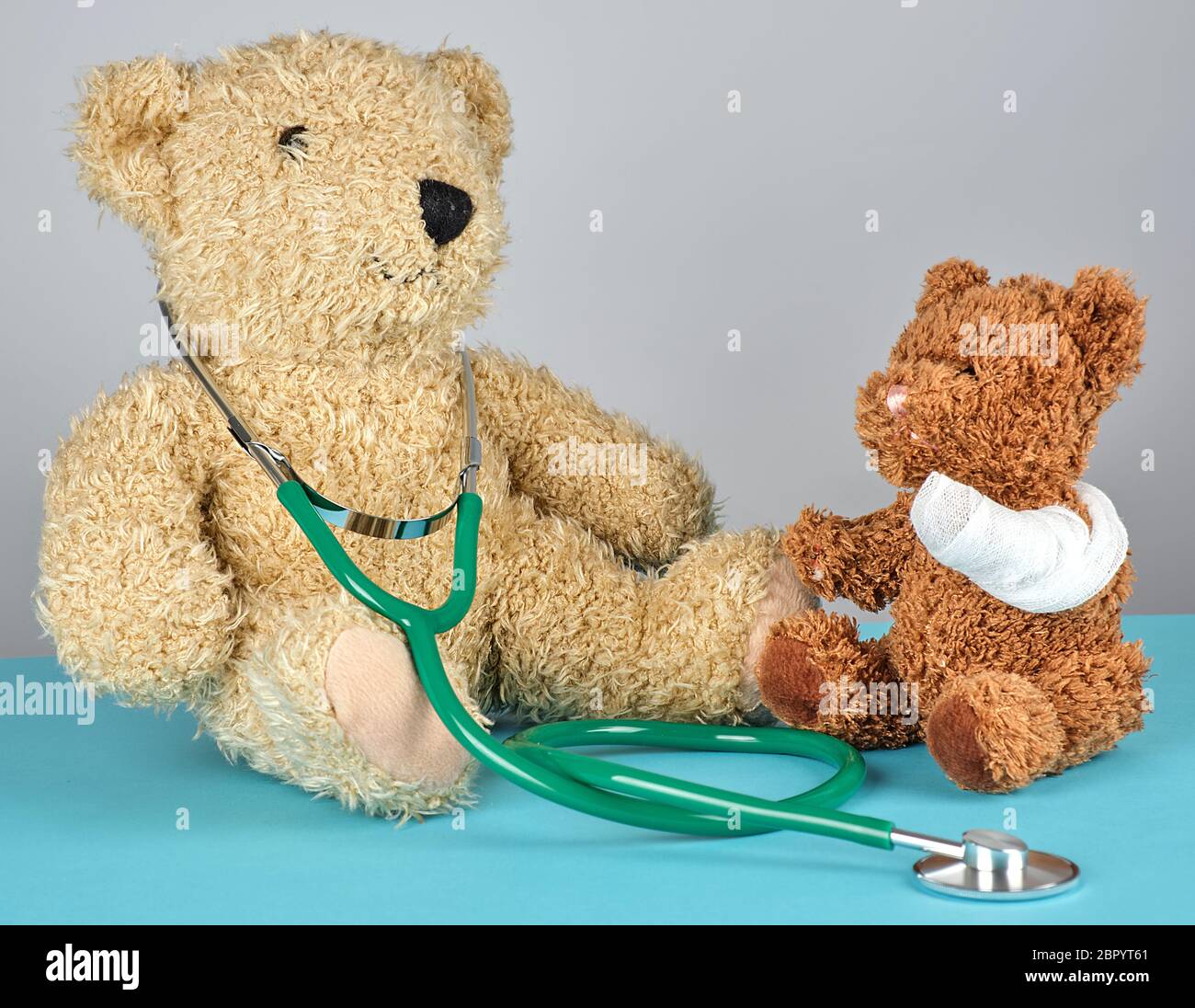 teddy bear with bandaged paw and stethoscope, pediatrics concept Stock ...