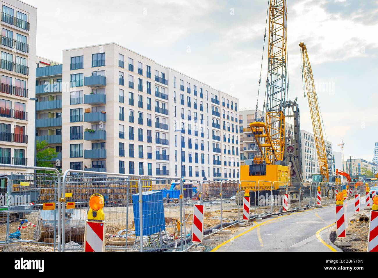 Excavator, cranes and construction equipment at construction site in ...