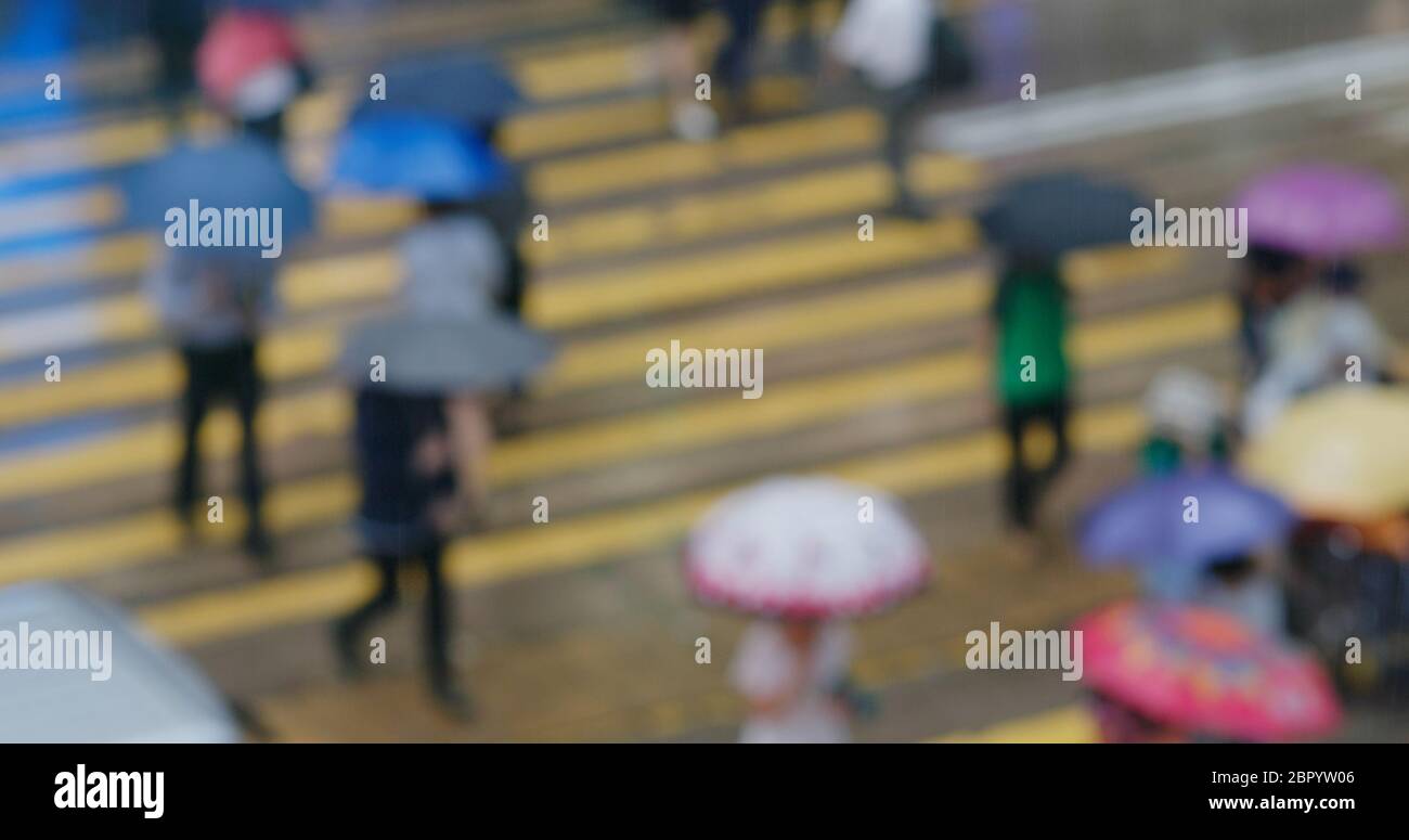 Women cross in rain hi-res stock photography and images - Alamy