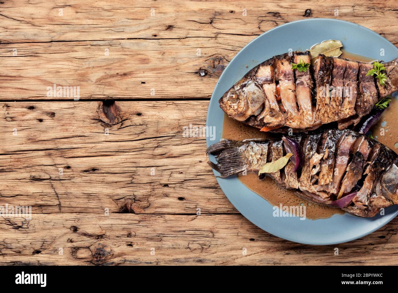 Grilled fish with lemon on rustic dark wooden background Stock Photo ...