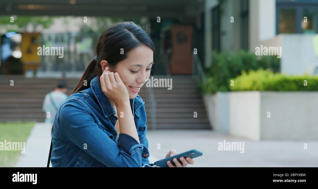 Woman listen to music on mobile phone Stock Photo - Alamy