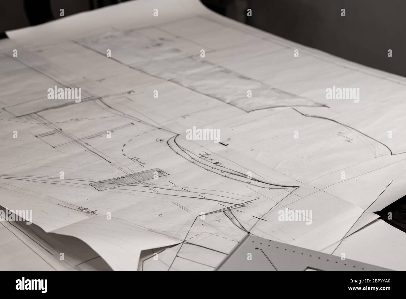 A tailor's work table with suit pattern for a jacket cut and marked up ...