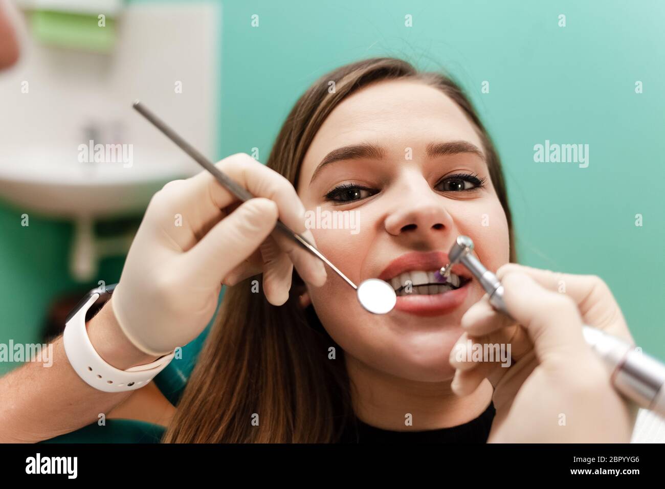 The doctor treats the patient's teeth with a drill close-up Stock Photo ...